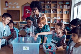 Cross Country Education color photo of a female teacher with two young ...