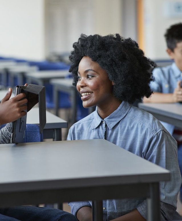color photo of a teacher with her student.