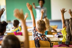 Cross Country Education color photo showing students with their hands ...